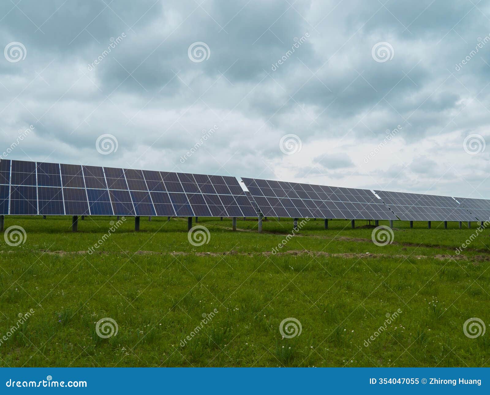 Solar Panels in a Field Under a Cloudy Sky. Clean Energy Solution Stock ...