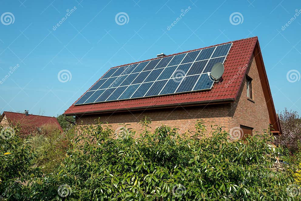 Solar panels on a red roof stock image. Image of house - 58257487