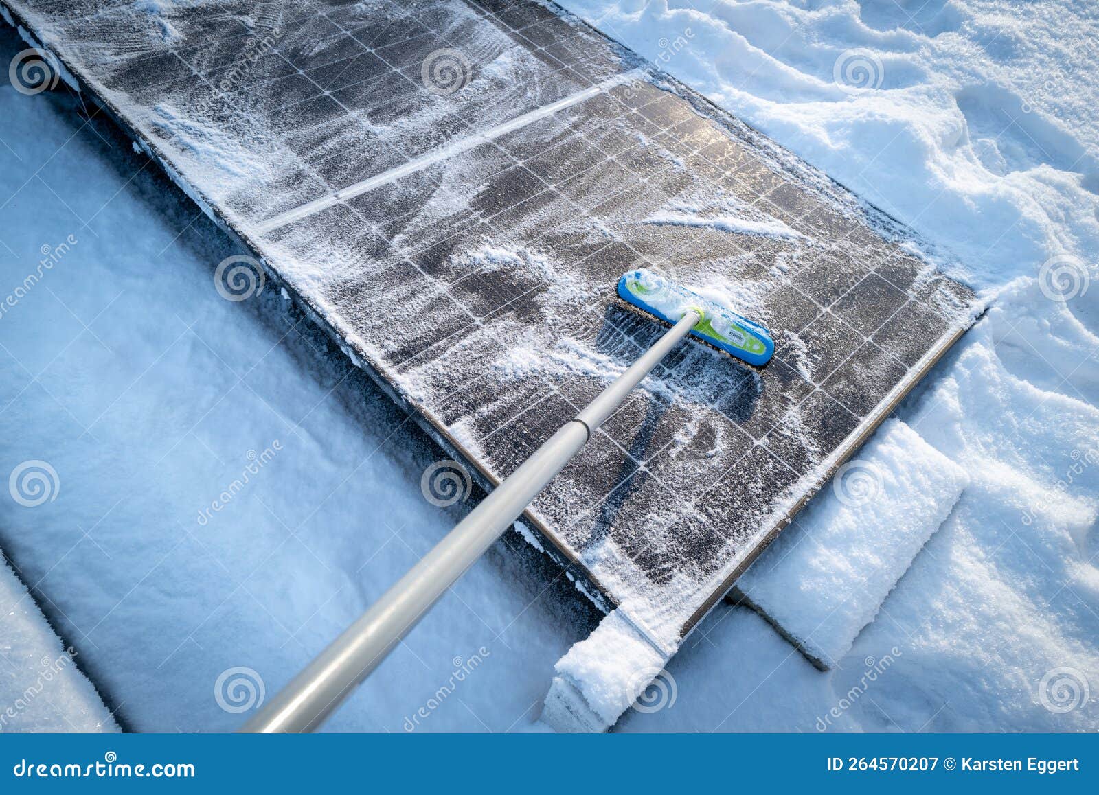 Solar Panels on the Roof are Cleaned from Snow with the Broom Stock ...