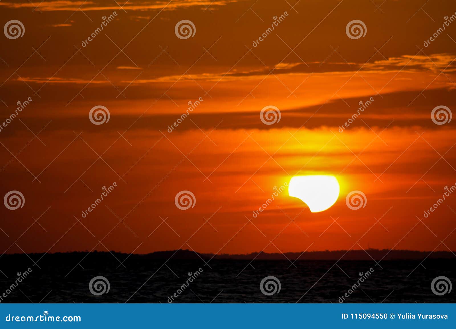 Solar Partly Eclipse at Sunset Stock Photo - Image of horizon, glow ...