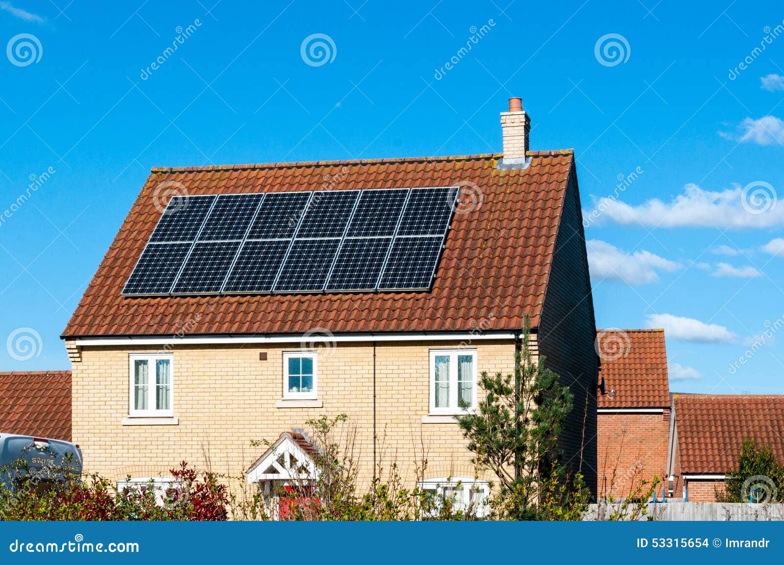 Solar Photovoltaic Panel Array on House Roof Against a Blue Sky Stock ...