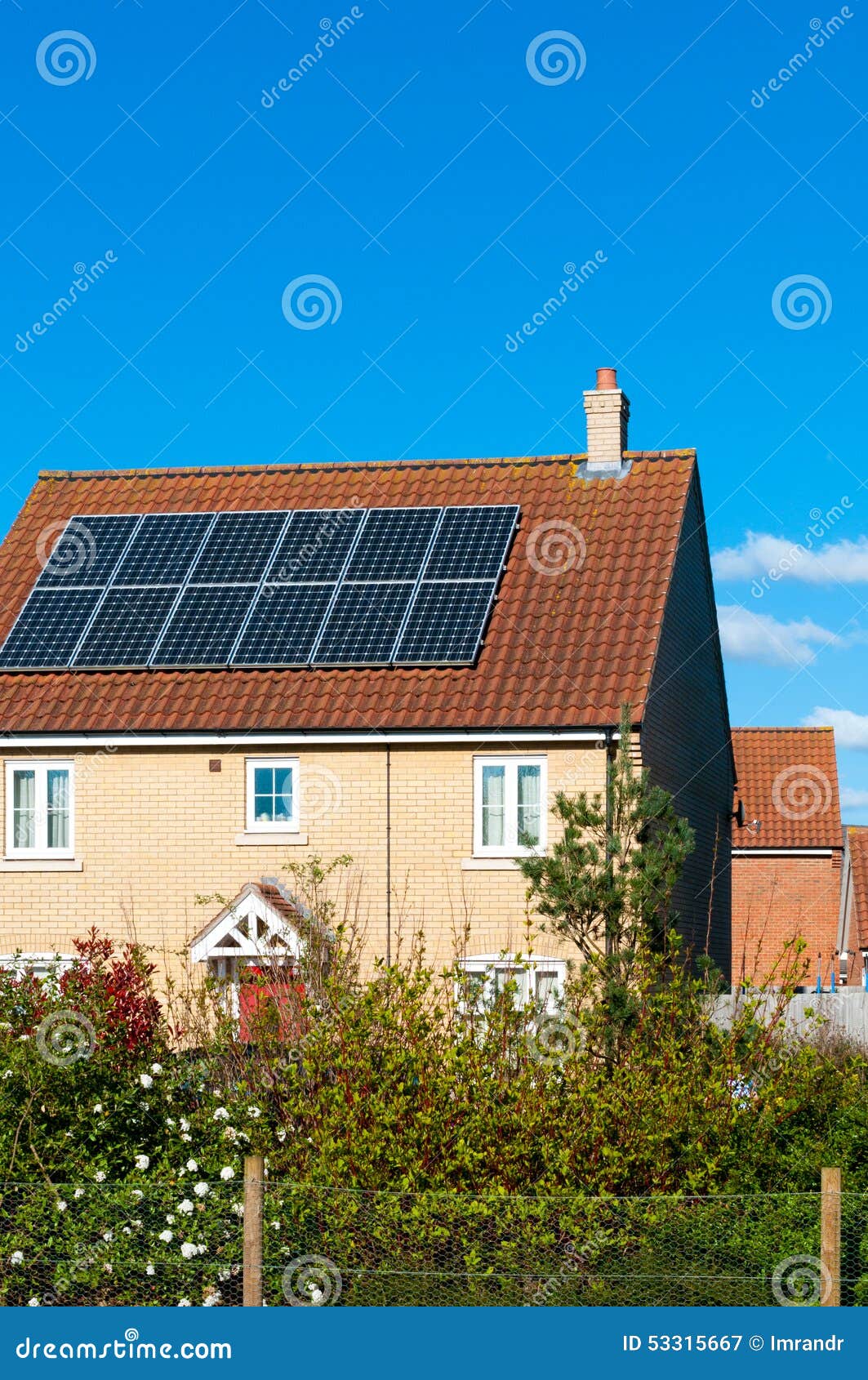Solar Photovoltaic Panel Array on House Roof Against a Blue Sky Stock ...