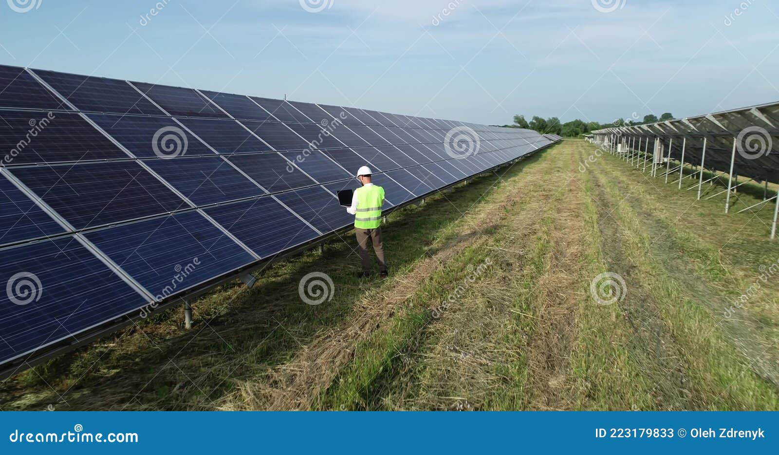 Solar Power Engineer Working on a Solar Farm. Drone Shot Stock Image ...