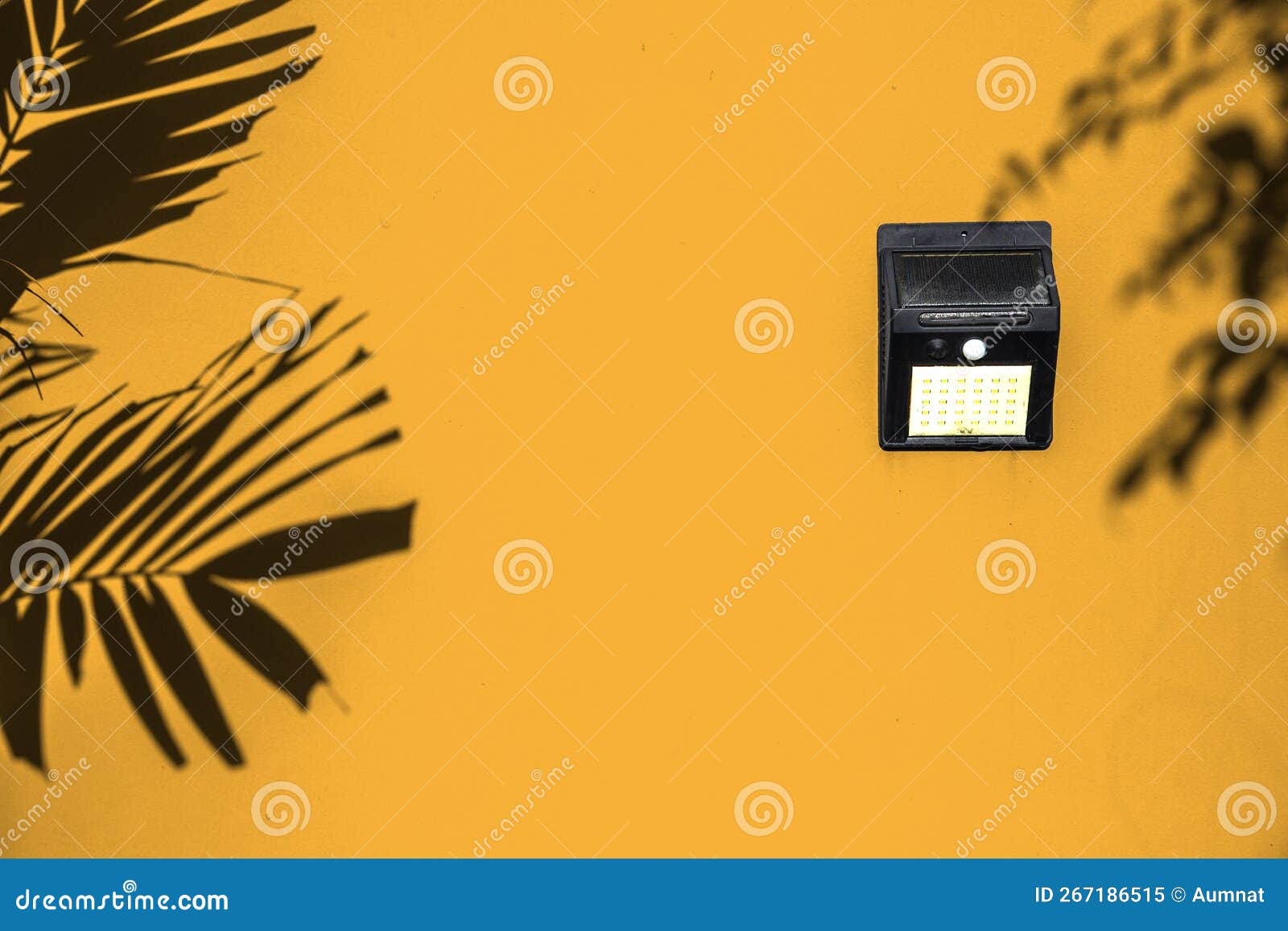 Solar-powered Motion Sensor Light Isolated on Yellow Cement or Concrete ...