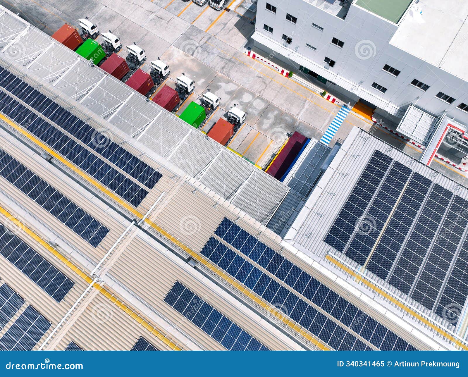 Solar-powered Warehouse Facility with Freight Trucks at Loading Docks ...
