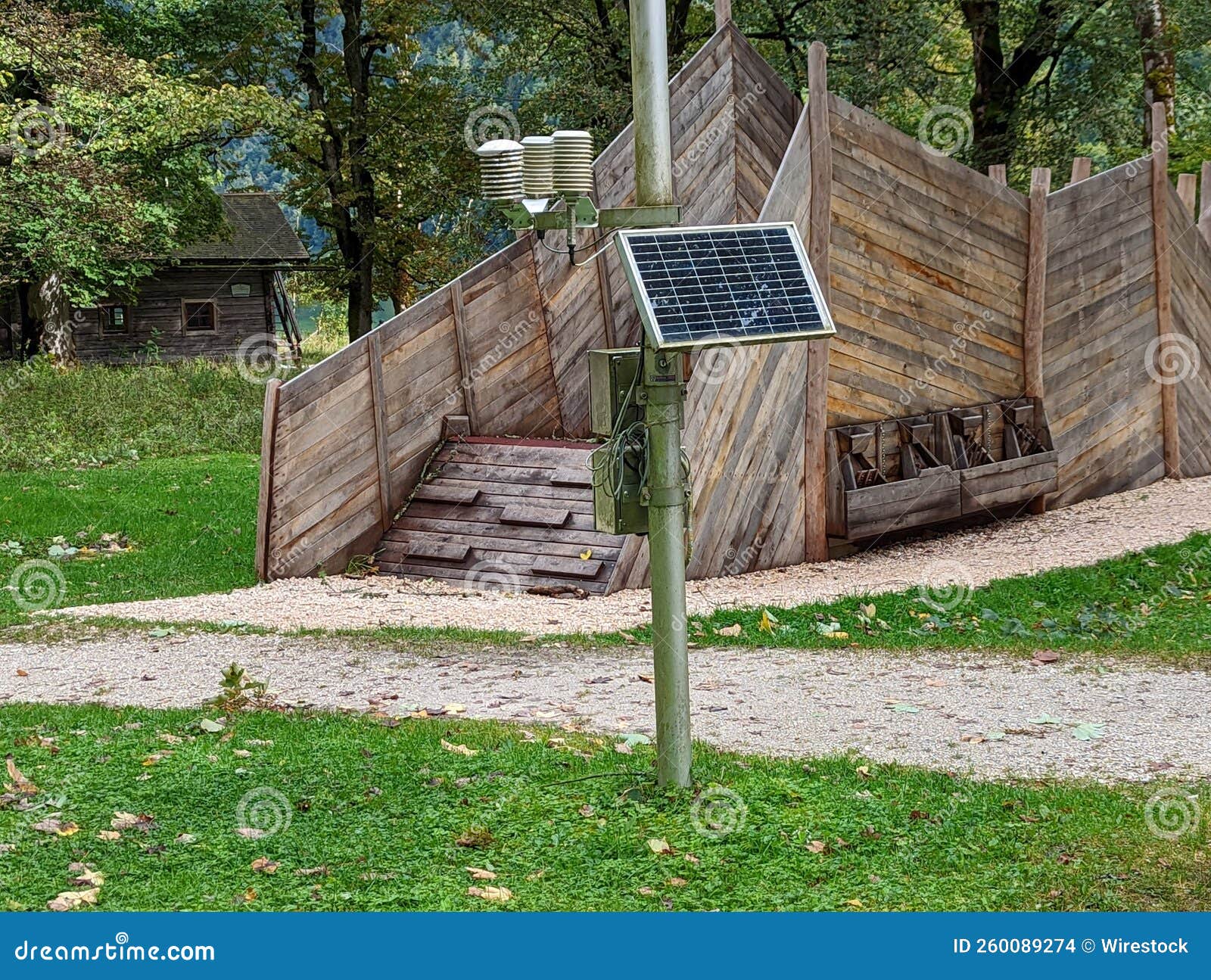 Solar Powered Weather Station in Front of Playground with Hut and Path ...