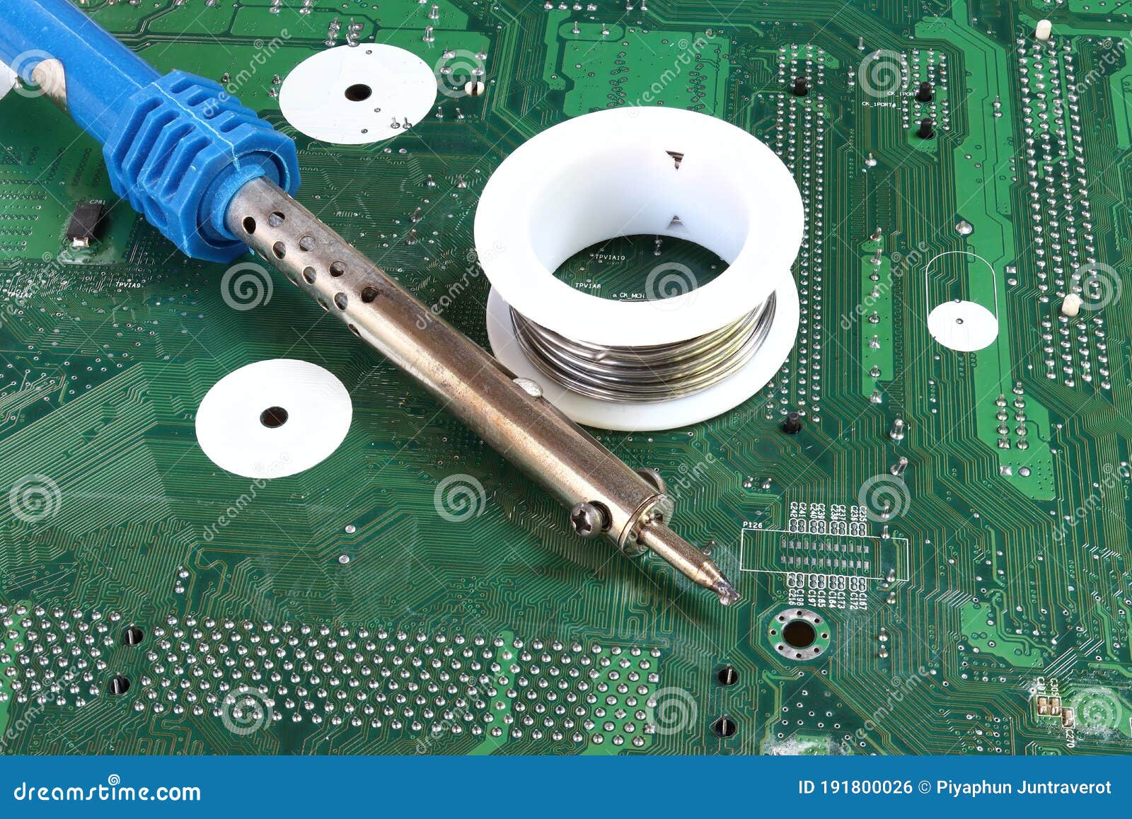 Soldering Iron on Green Mainboard for Repairing Electronic of the ...