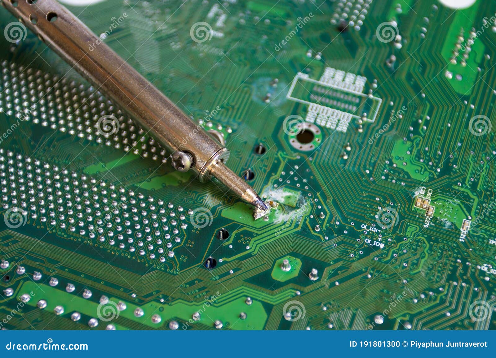 Soldering Iron on Green Mainboard for Repairing Electronic of the ...