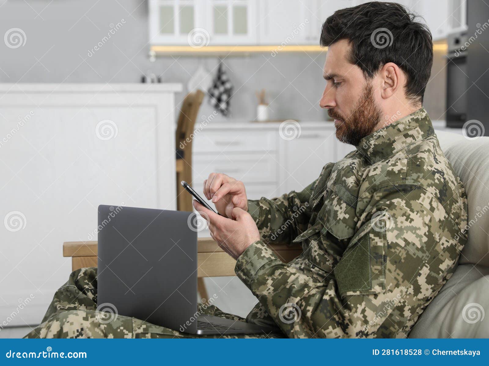 Soldier with Laptop Using Smartphone at Home Stock Photo - Image of ...