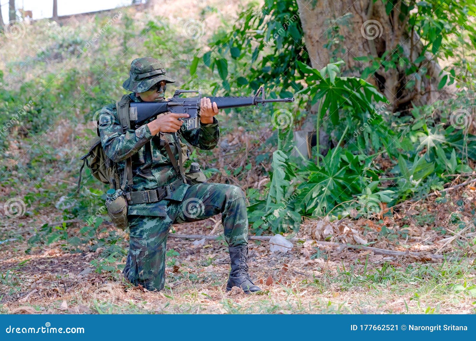 Soldier Man with Backpack Point the Gun To Front Direction and Prepare ...