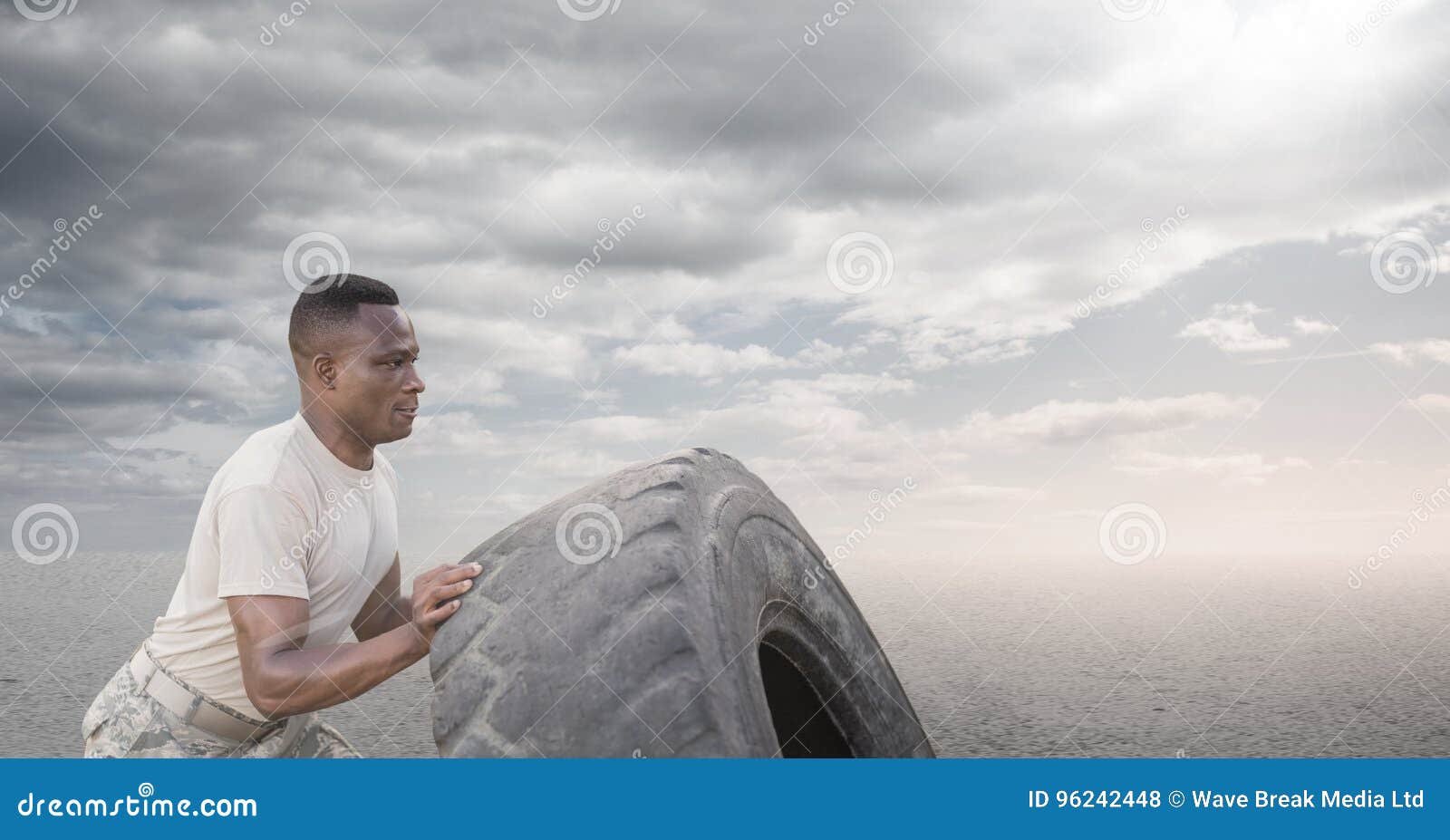 Soldier Man Pushing a Wheel Against Desert Background Stock Photo ...