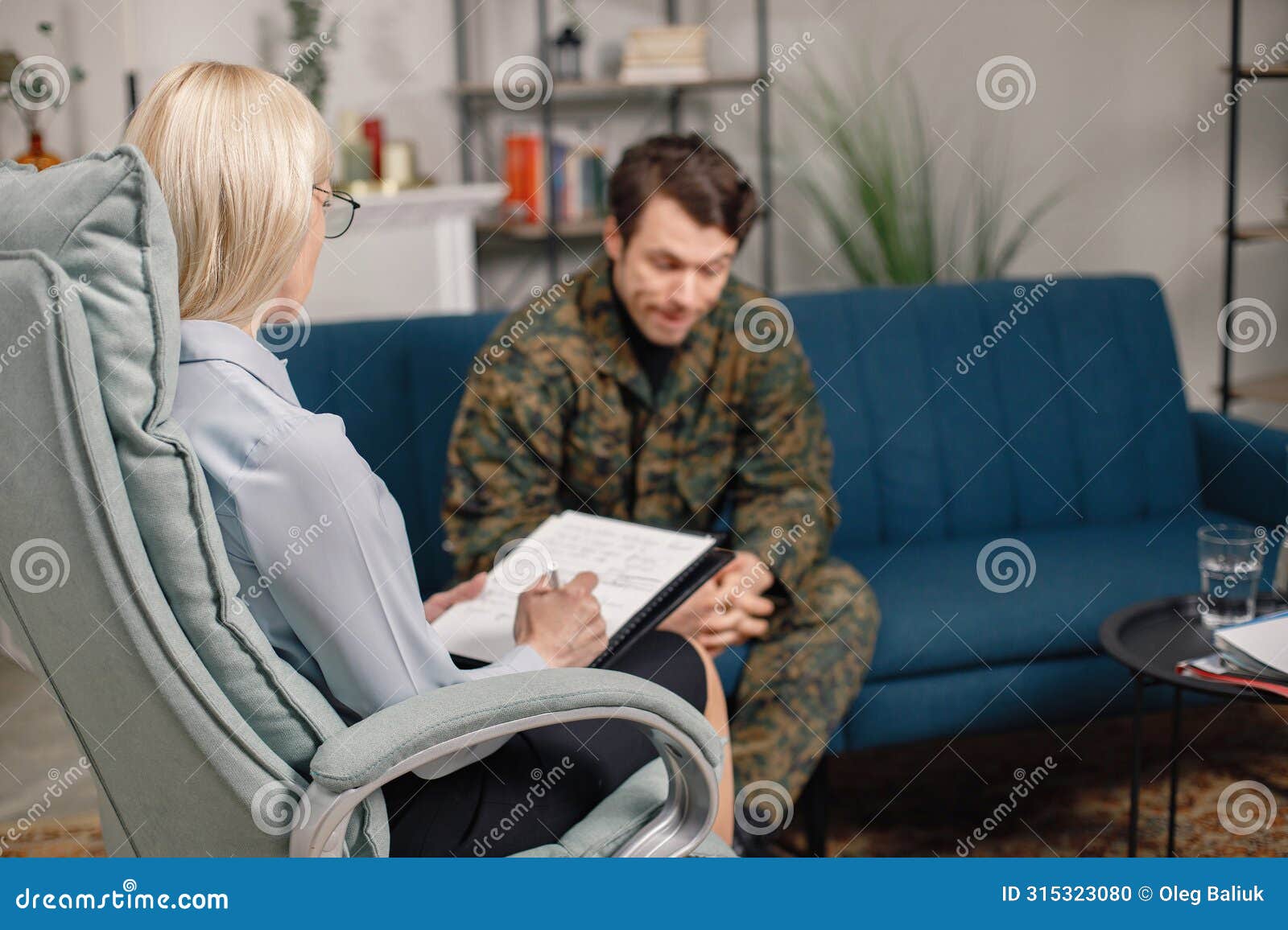 Soldier In Military Uniform Talking To Psychiatrist At Therapy Session