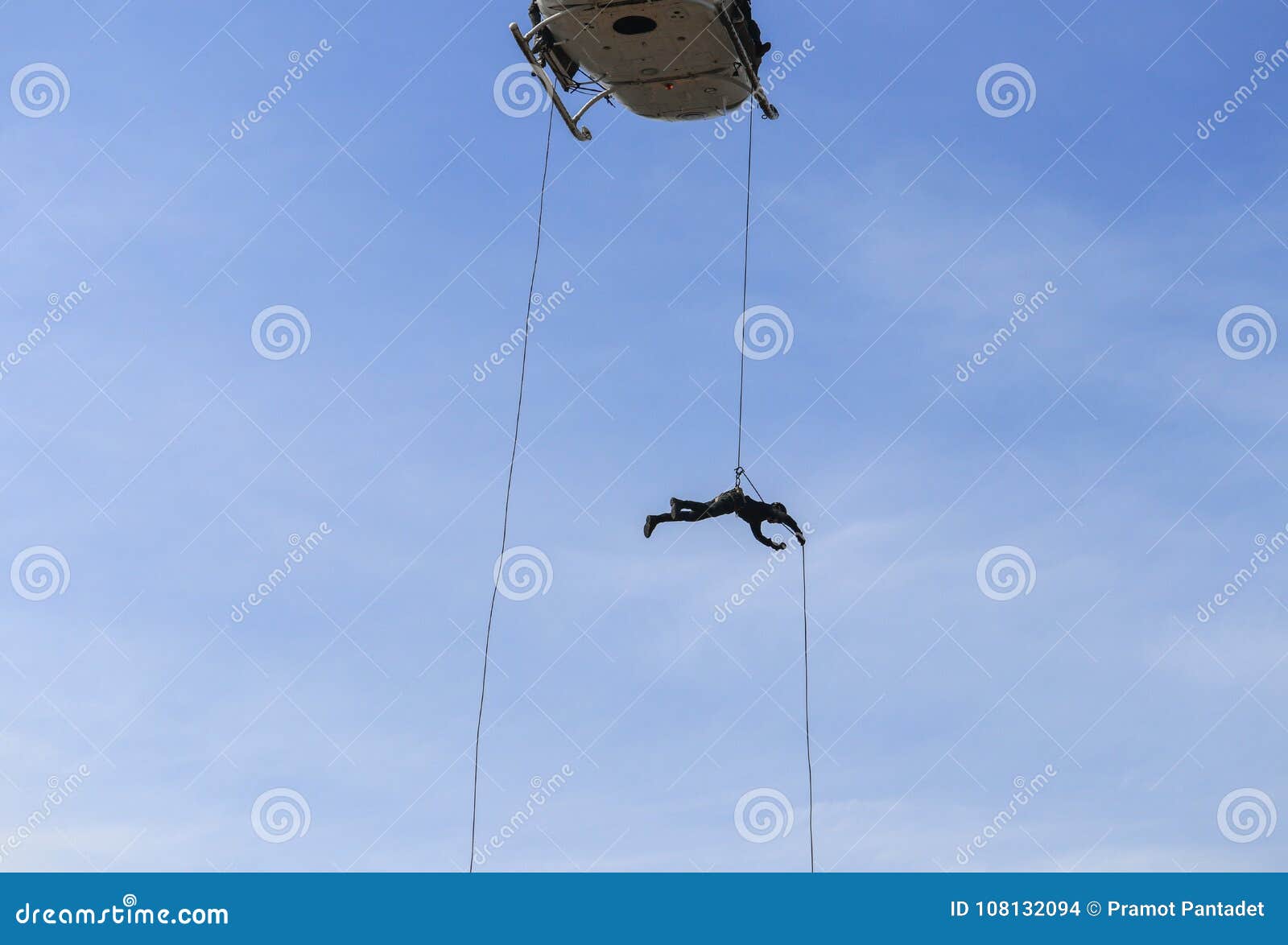 Soldier Rappelling From Helicopter In Blue. Sky With Blur Propell ...