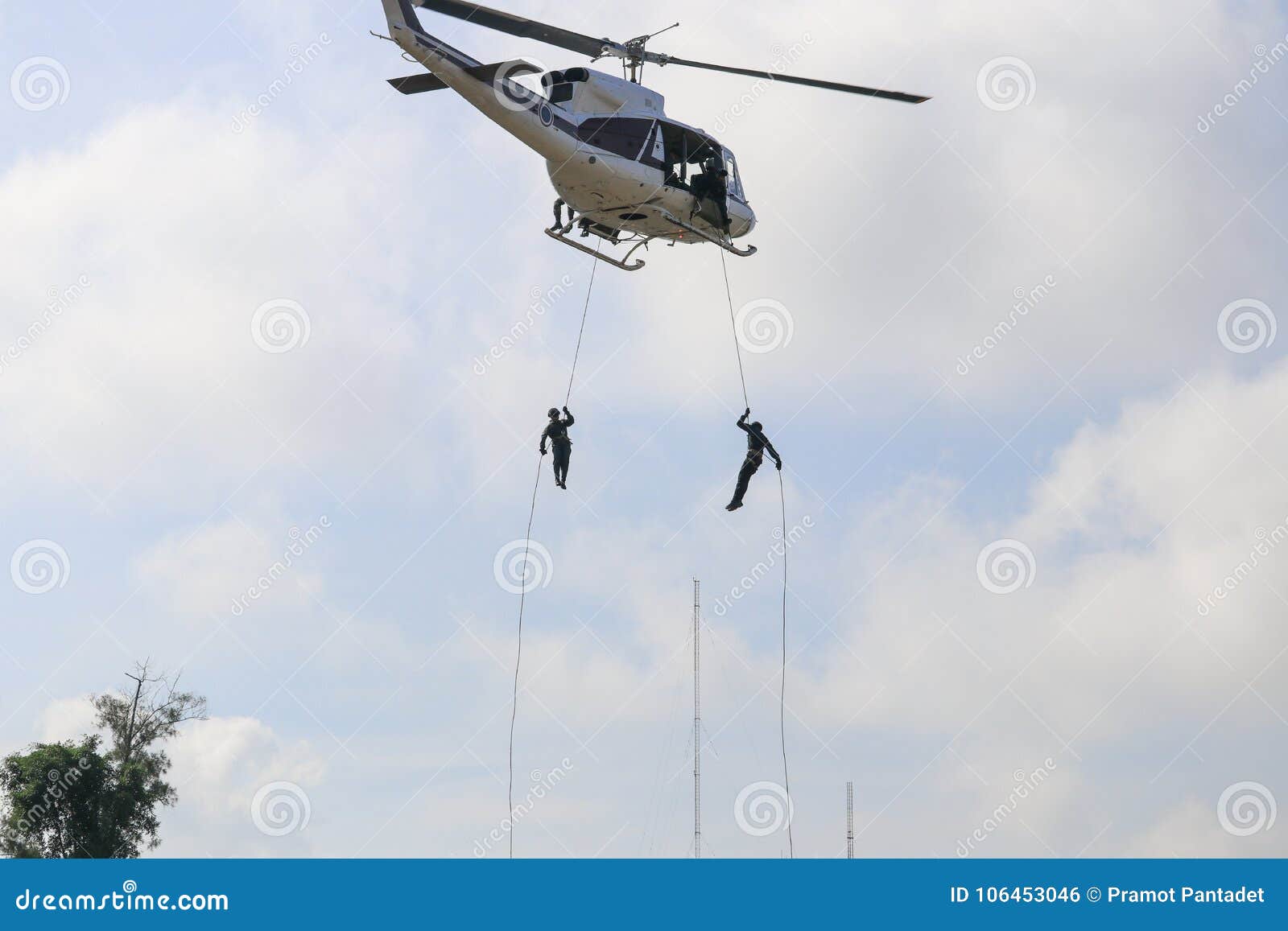 Soldier Rappelling from Helicopter in Blue Sky with Blur Propeller ...