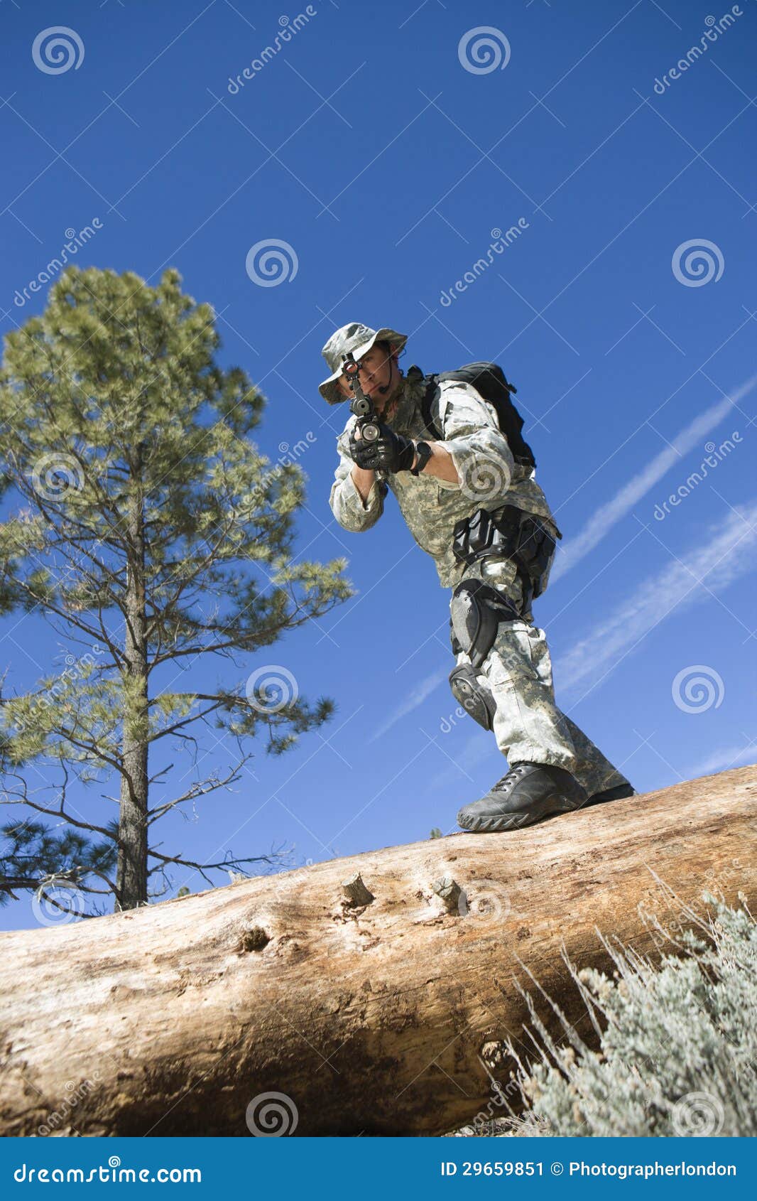 Soldier with Rifle Standing on Tree Trunk Stock Image - Image of combat ...