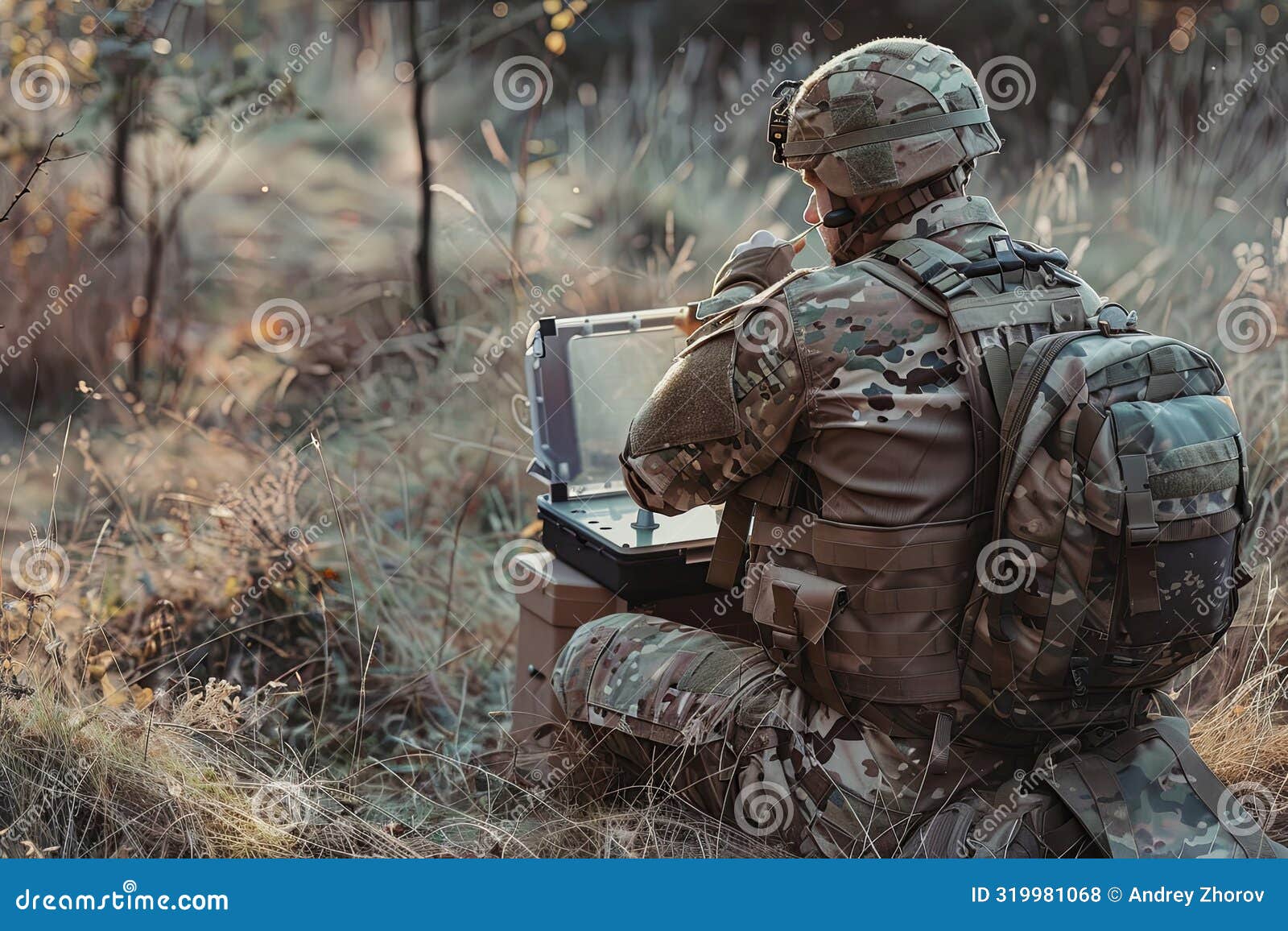 A Soldier Sitting in a Field Using a Laptop To Create 3D Objects Stock ...