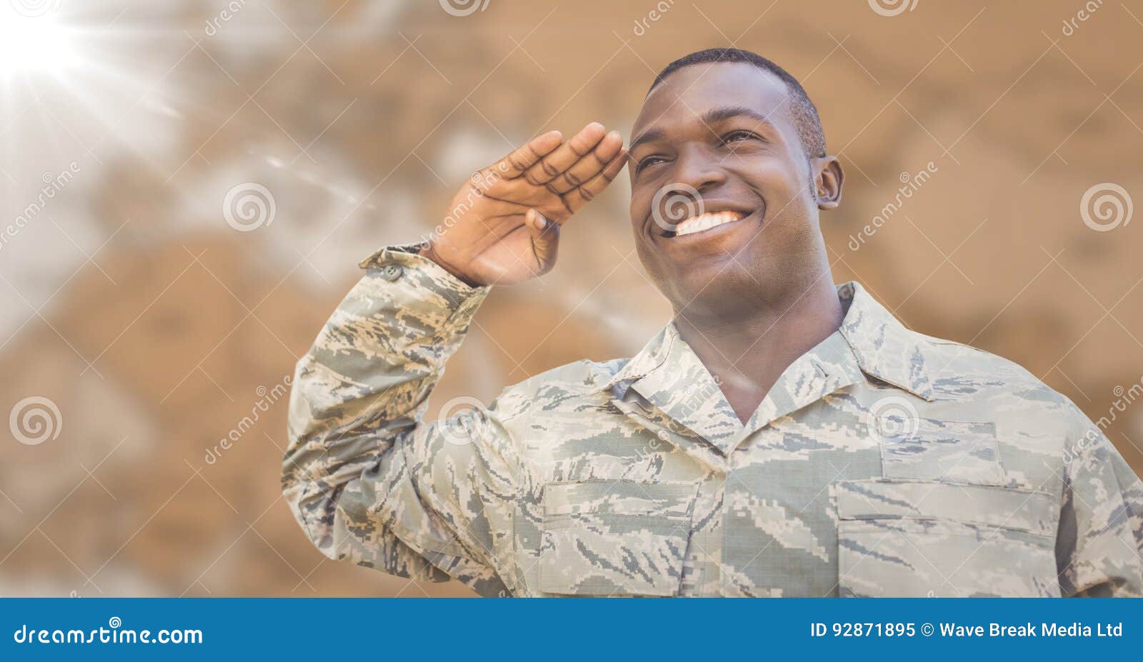 Soldier Smiling and Saluting Against Blurry Brown Map with Flare Stock ...