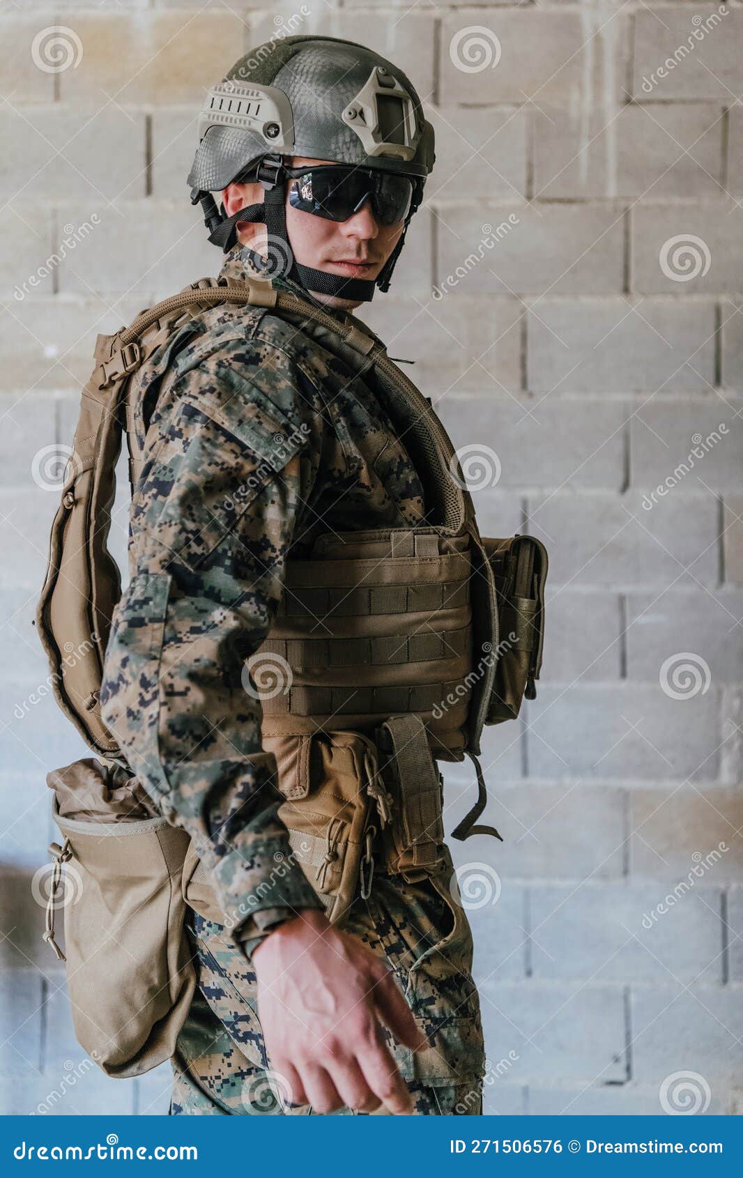 A Soldier in Uniform Stands in Front of a Stone Wall in Full War Gear ...