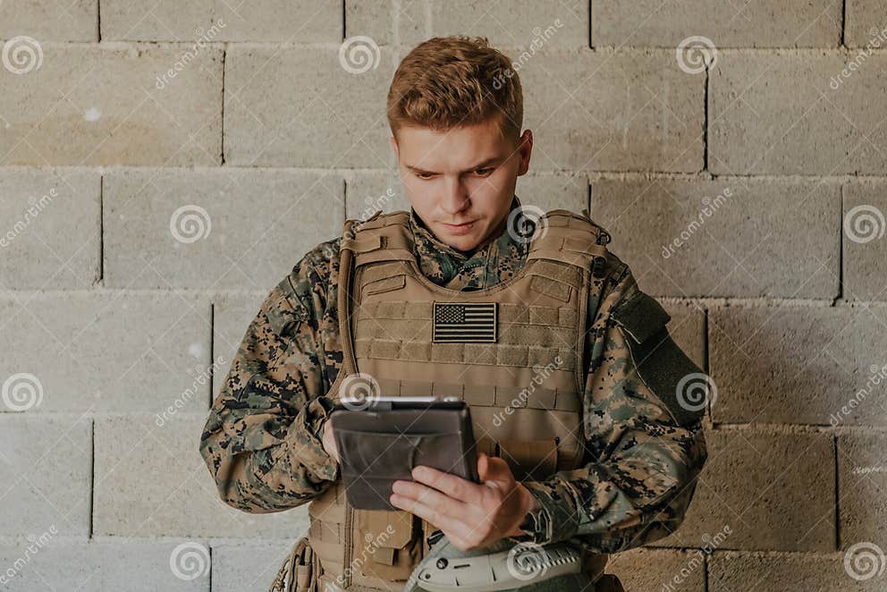 Soldier Using Tablet Computer Against Old Brick Wall Stock Photo ...