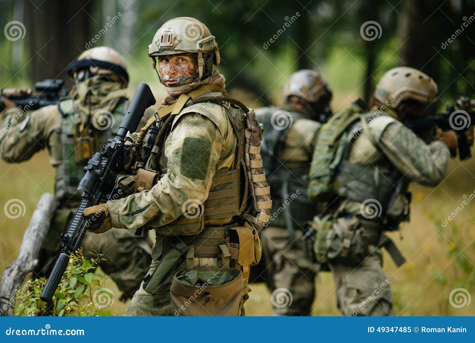 Soldiers standing with arms and looks back