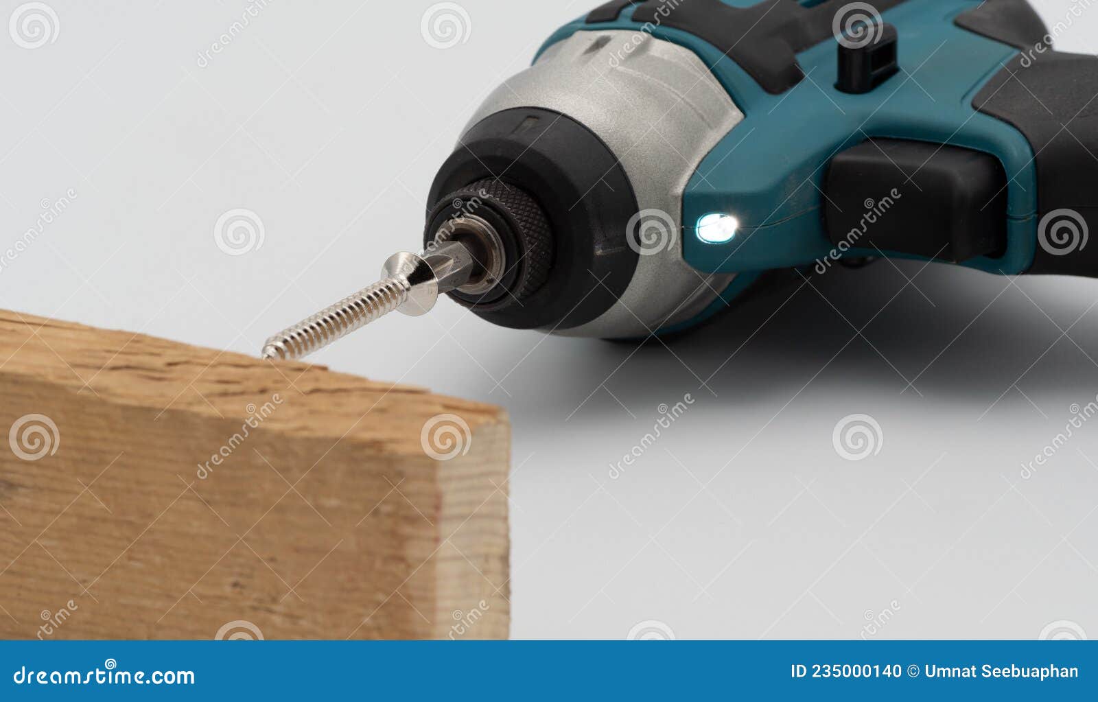 On the Solid Wood Work Bench, a Carpenter Uses an Electric Screwdriver ...
