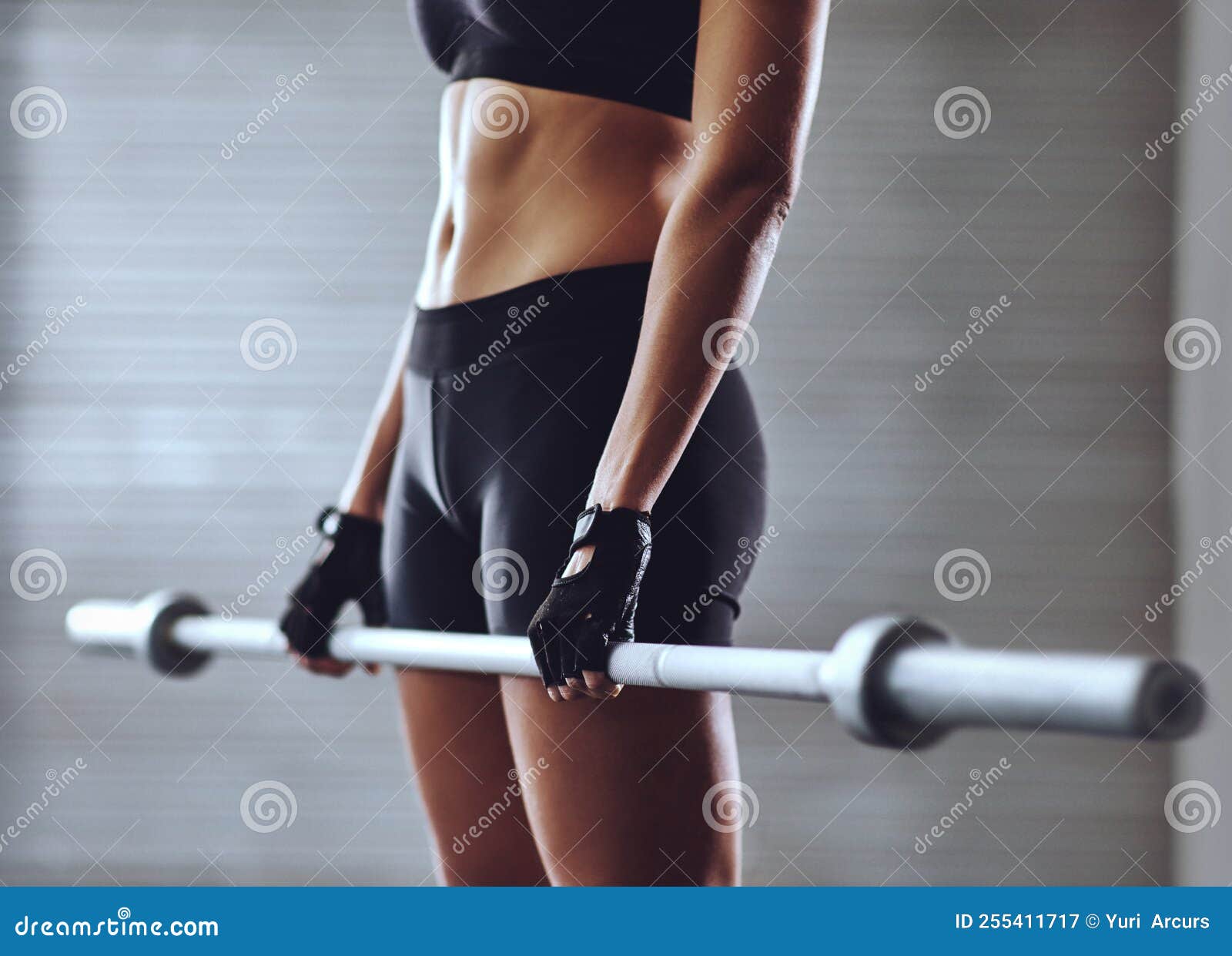 Solid Workouts Build Solid Bodies. a Woman Training with Weights at the ...