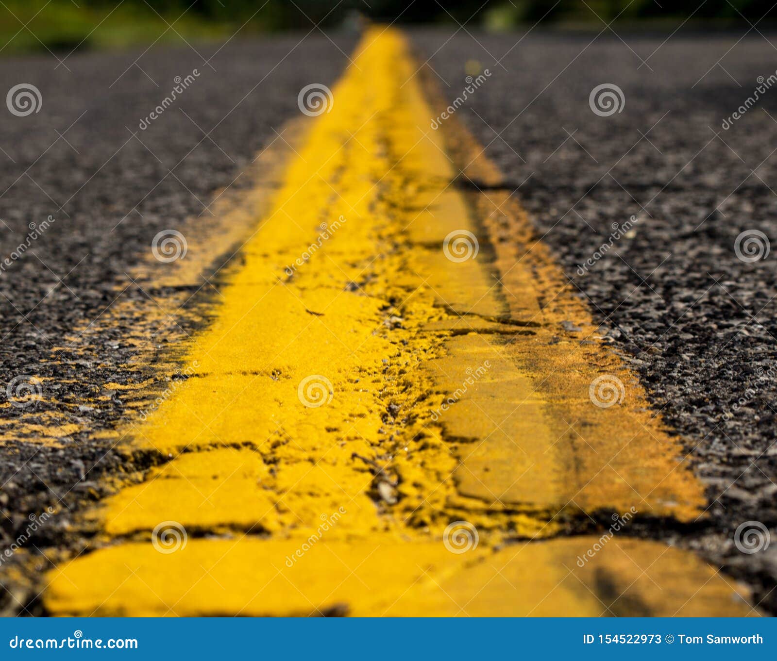 Solid Yellow Line Down a Road with Aged Pavement Stock Image - Image of ...