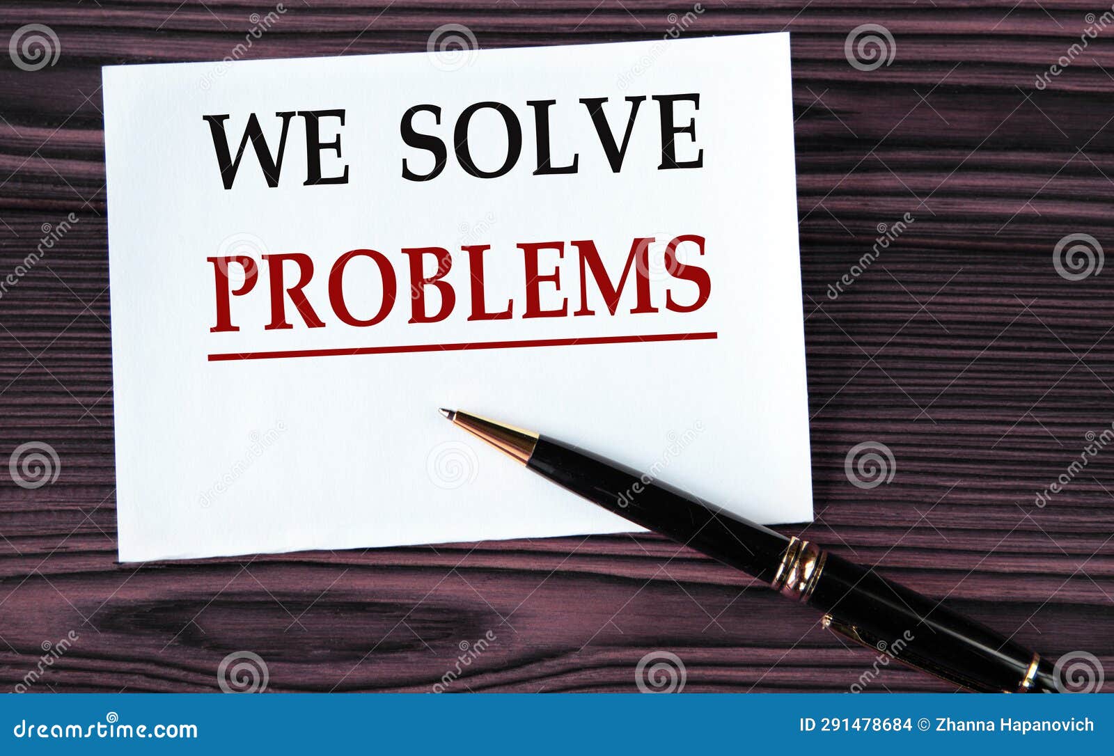 We SOLVE PROBLEMS - Words on a White Sheet on a Brown Wooden Background ...