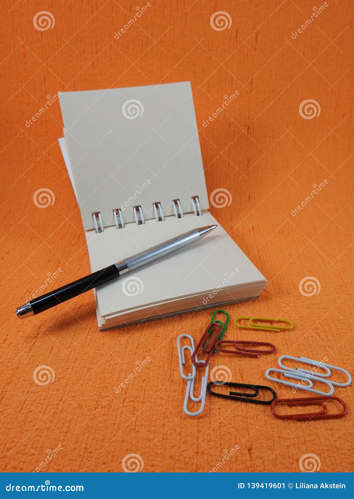 Some Colored Paper Clips, a Small Blank Notepad and a Pen. Stock Image ...