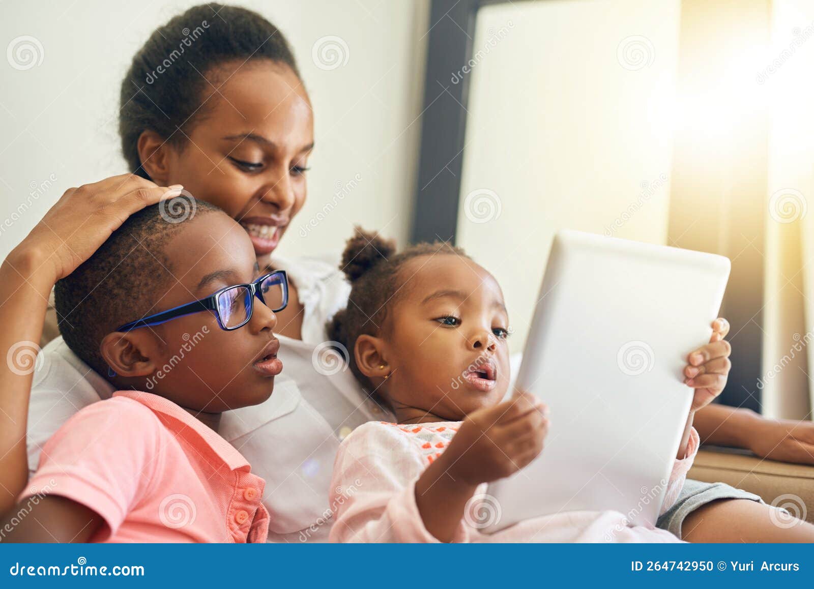 Some Family Down Time. an Affectionate Young Family Using a Tablet ...