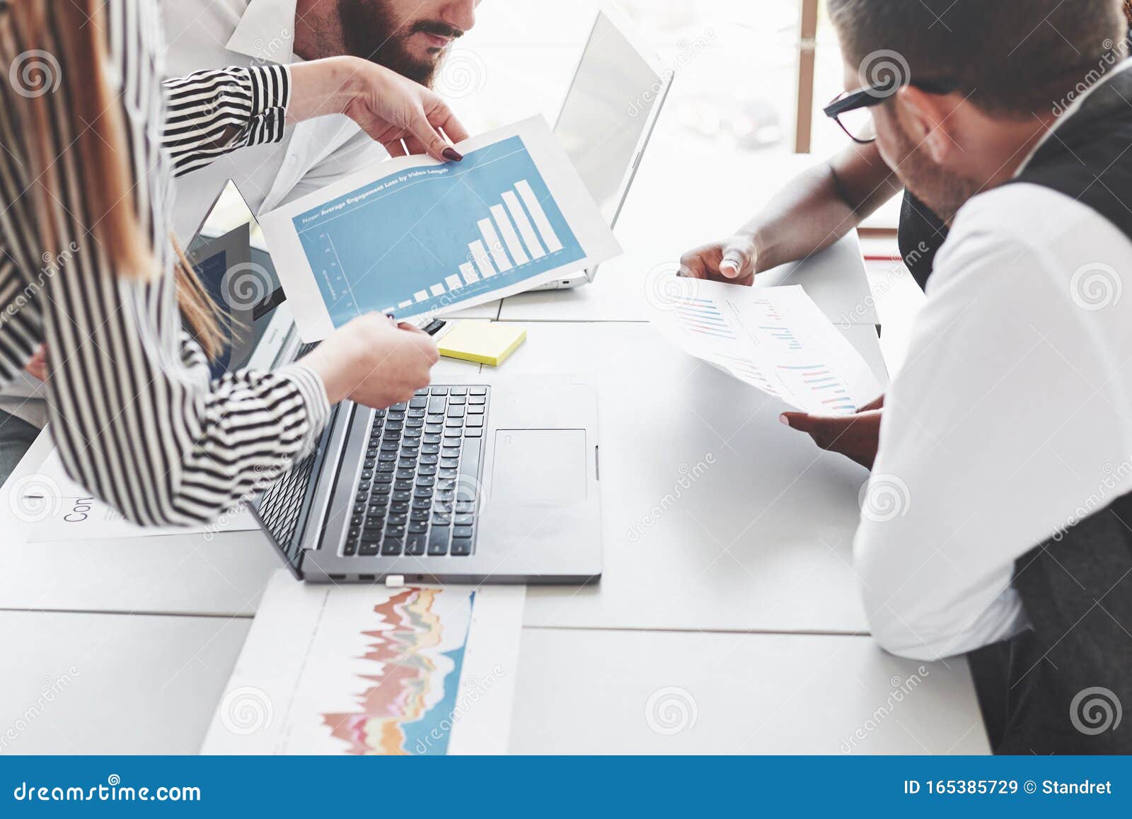 Some Graphs and Reports. Team Workers Have Meeting and Talking about ...