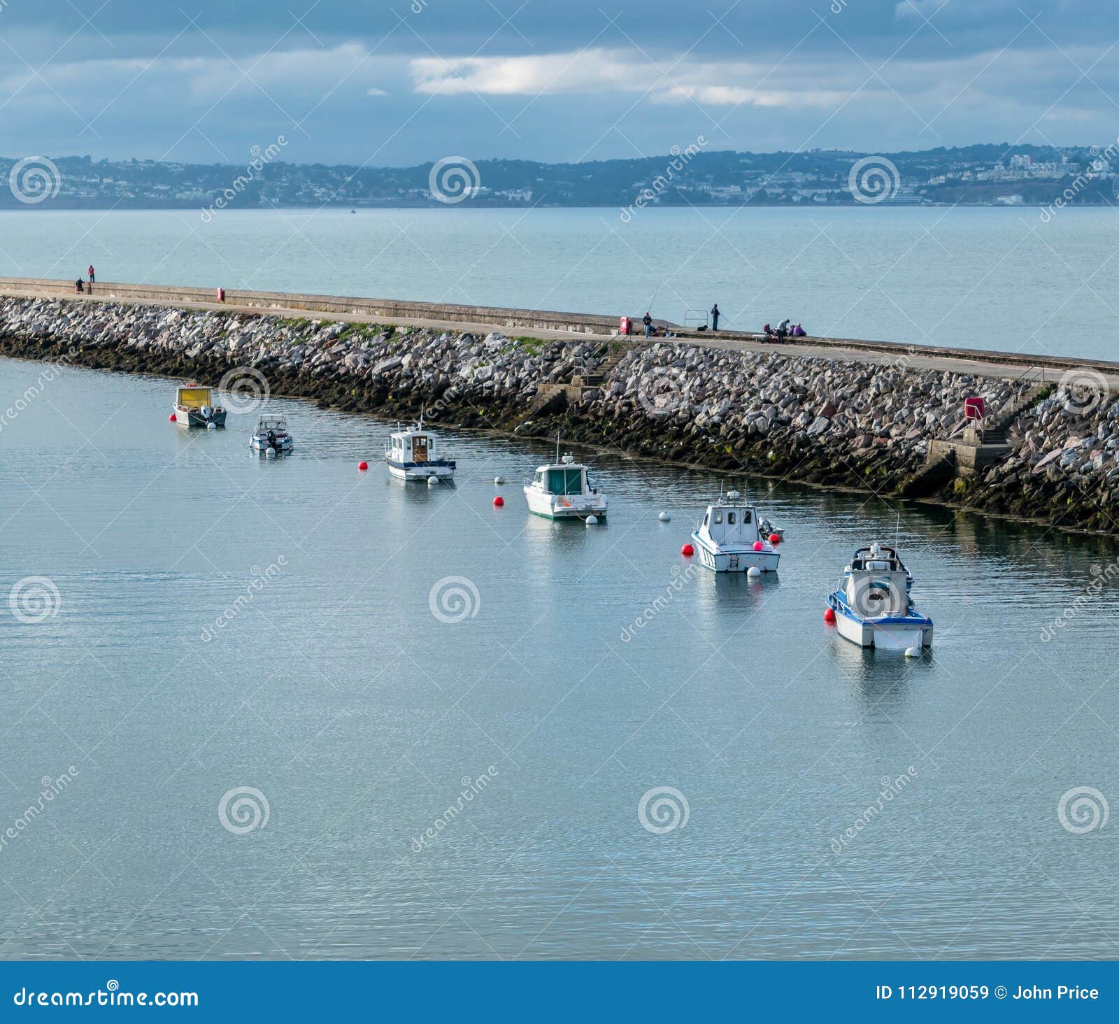Small Boats Moored by a Rock Pier Stock Image - Image of boat, harbor ...