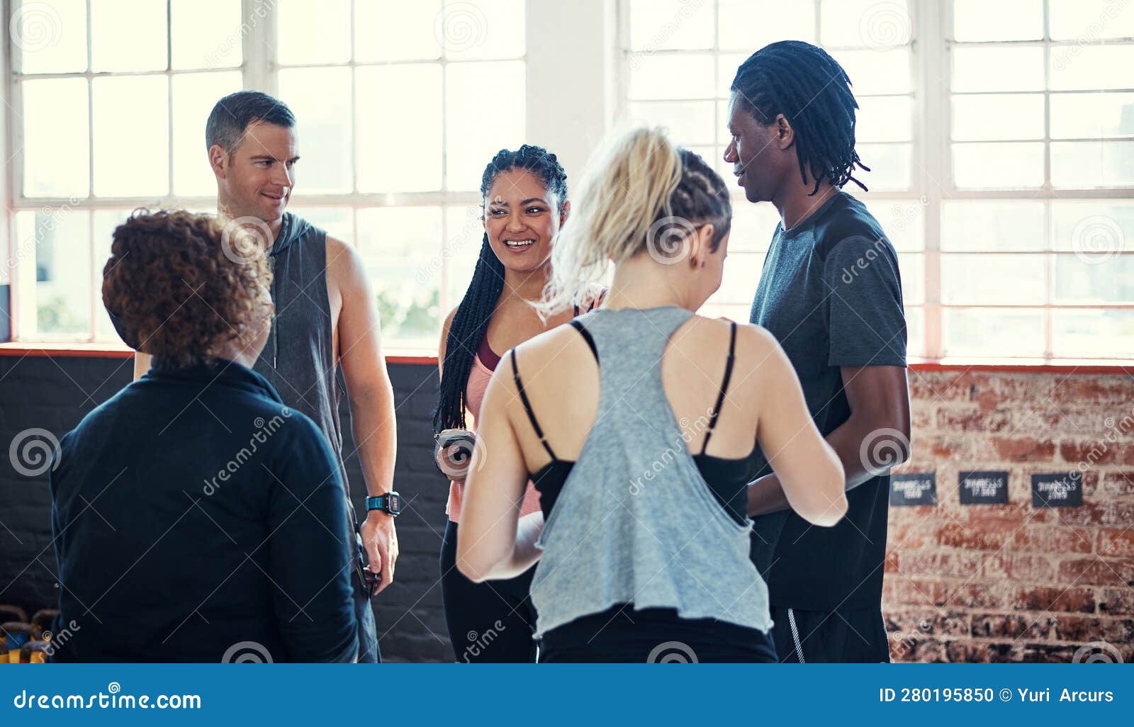 Some Workout Chit Chat. a Cheerful Young Group of People Standing in a ...