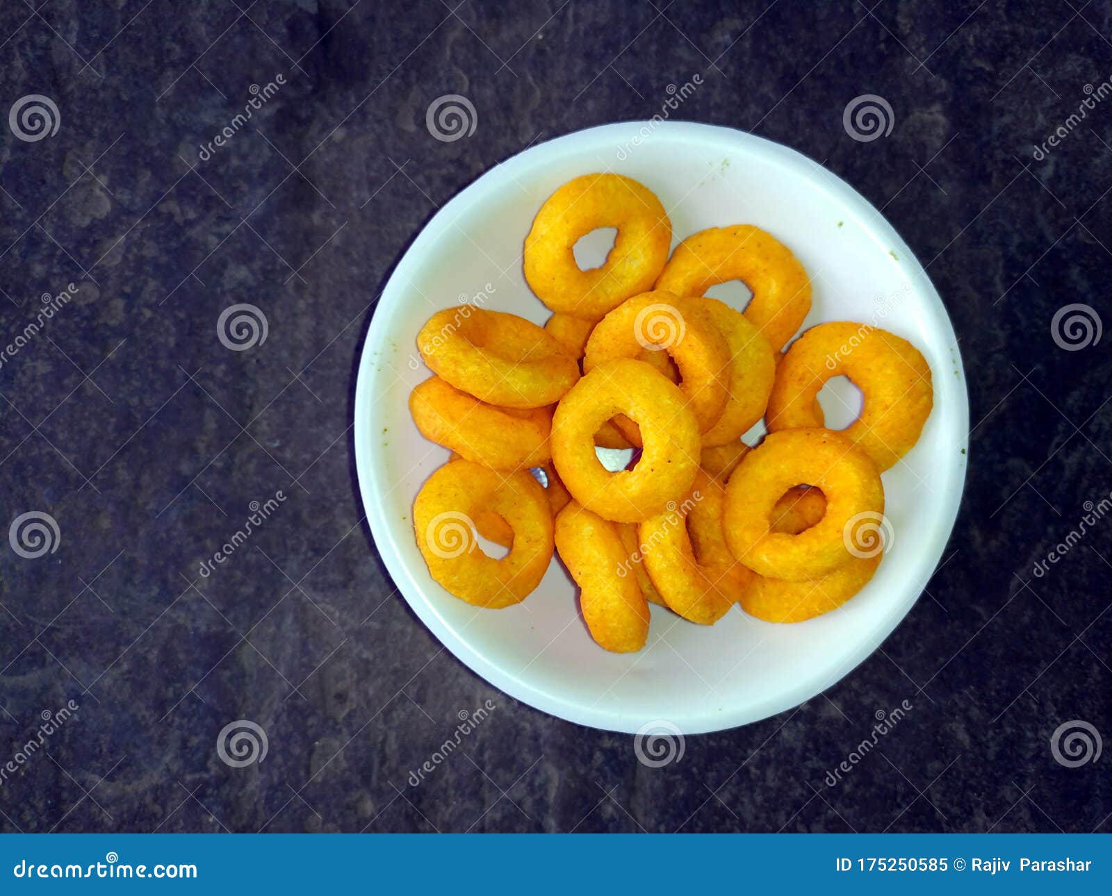 SOME YELLOW EATABLE FOOD PUT in a BOWL on STONE BACKGROUND Stock Image ...