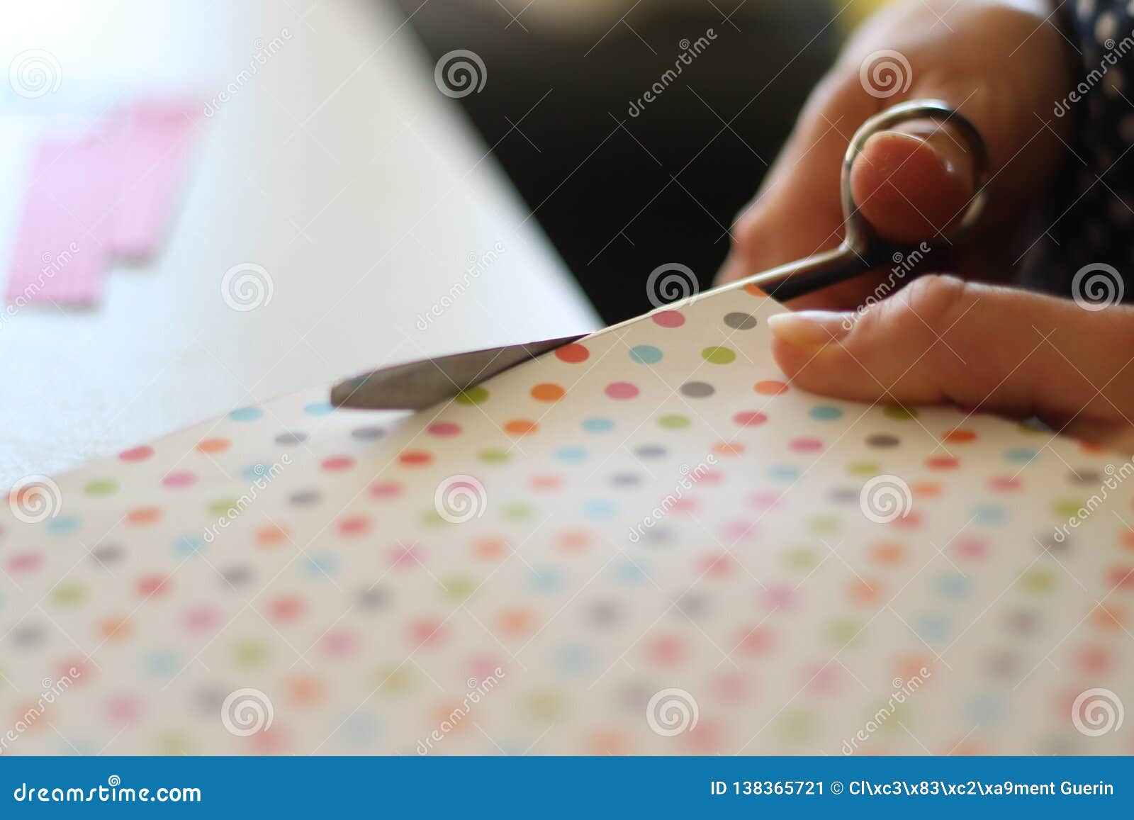 Someone cutting paper stock image. Image of hood, cutting - 138365721