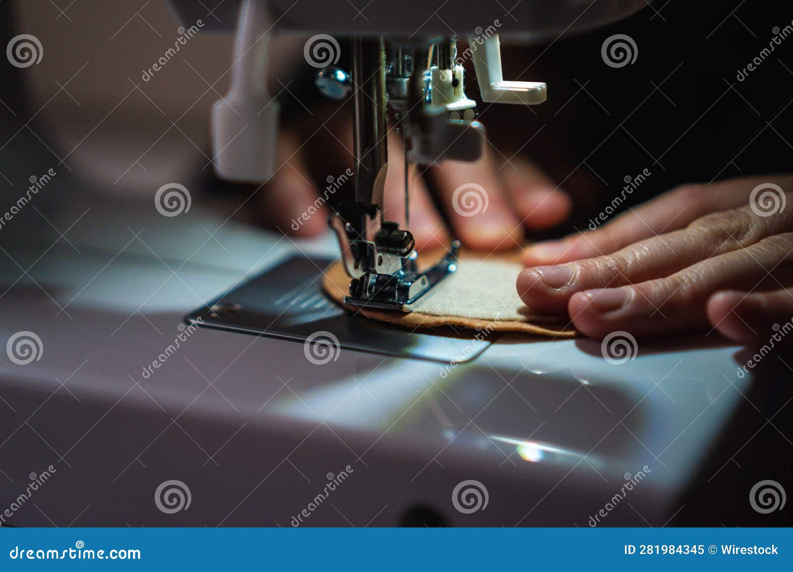 Someone is Sewing Something with Some Light on the Machine and Using it ...