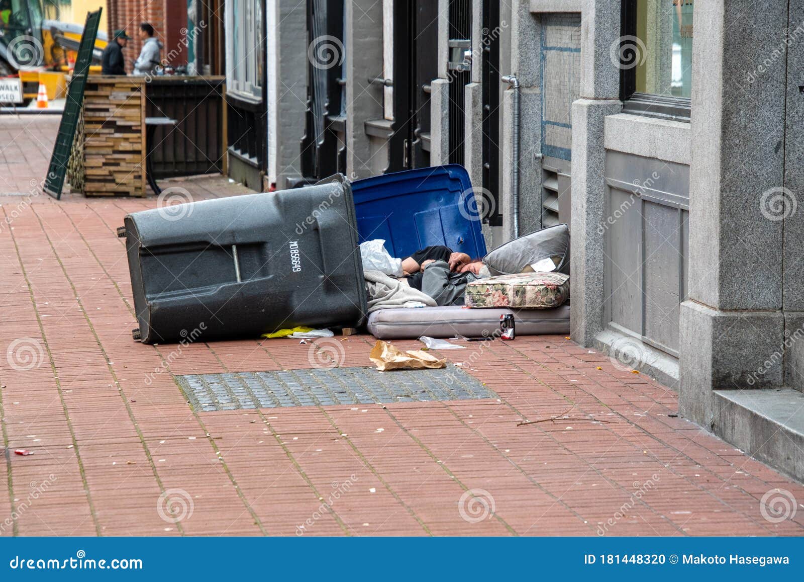 Someone Sleeping on the Streets Using a Large Garbage Bin As a Bed ...