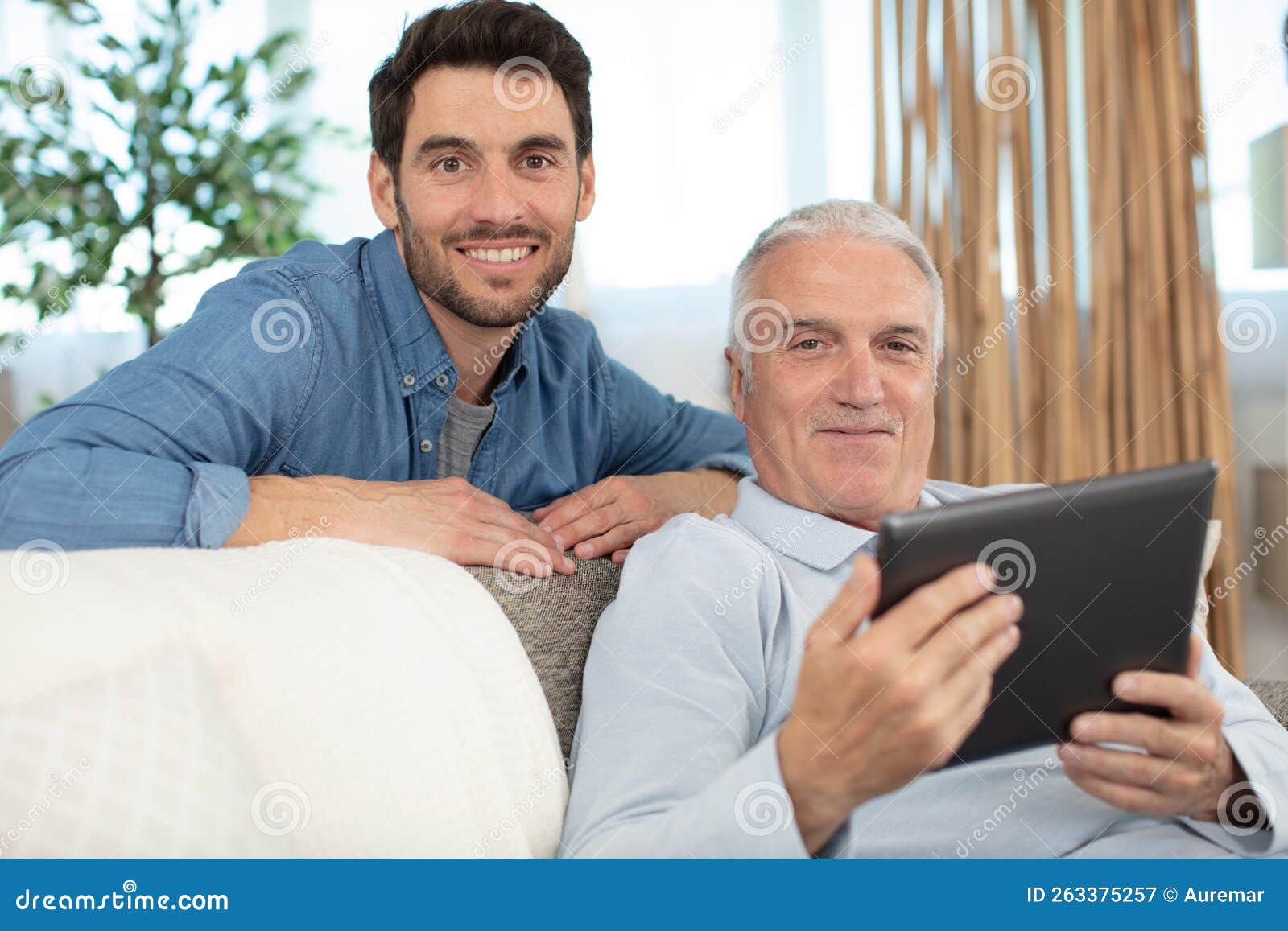 Son and Elderly Father Sit on Couch Stock Image - Image of joyhappiness ...