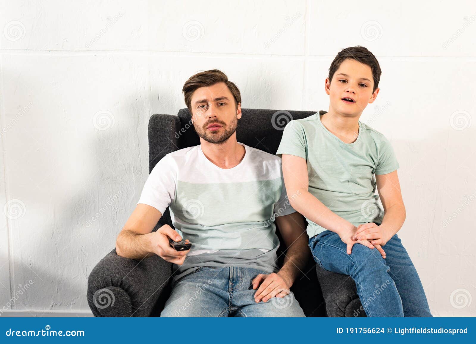 Son and Father with Remote Controller Watching Tv Stock Photo - Image ...