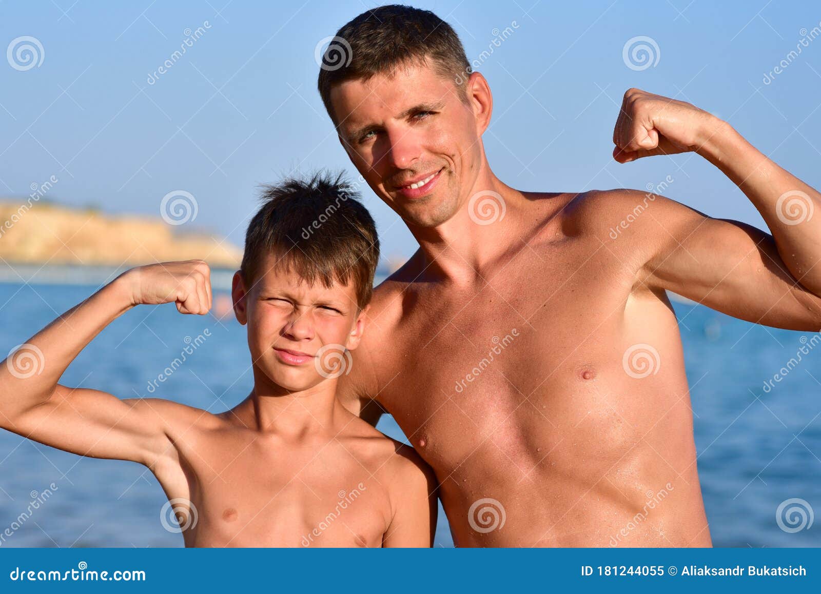 Son and Father Show Muscles at Sea Stock Image - Image of active ...