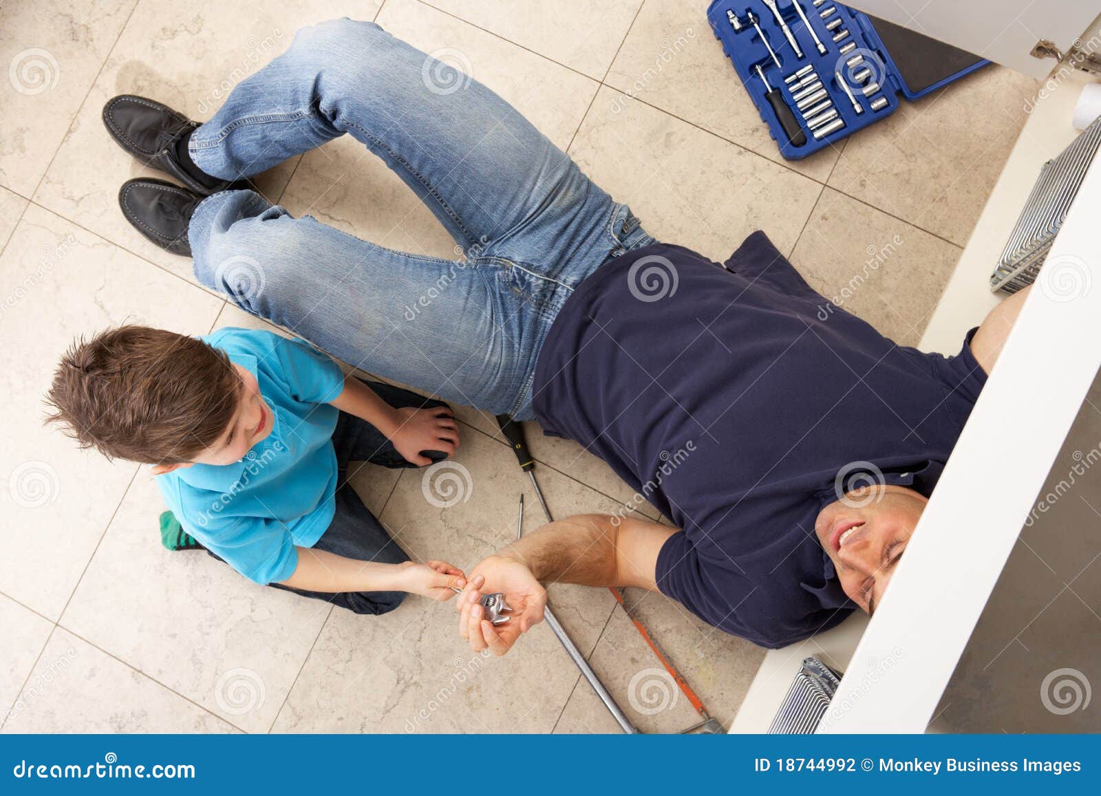 Son Helping Father To Mend Sink Stock Photo - Image of indoors ...
