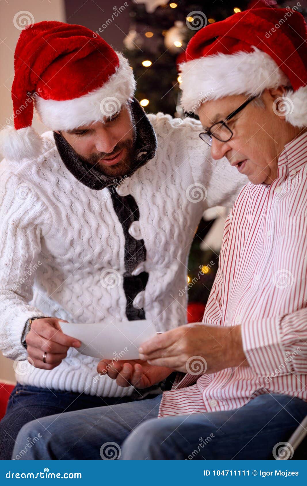 Son and His Father Watching Photo and Share Memory on Christmas Stock ...