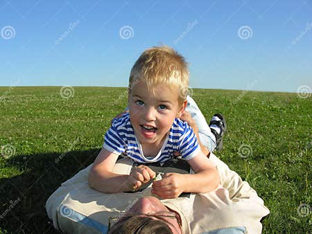 Son lie on father stock photo. Image of grass, parent, childhood - 237704