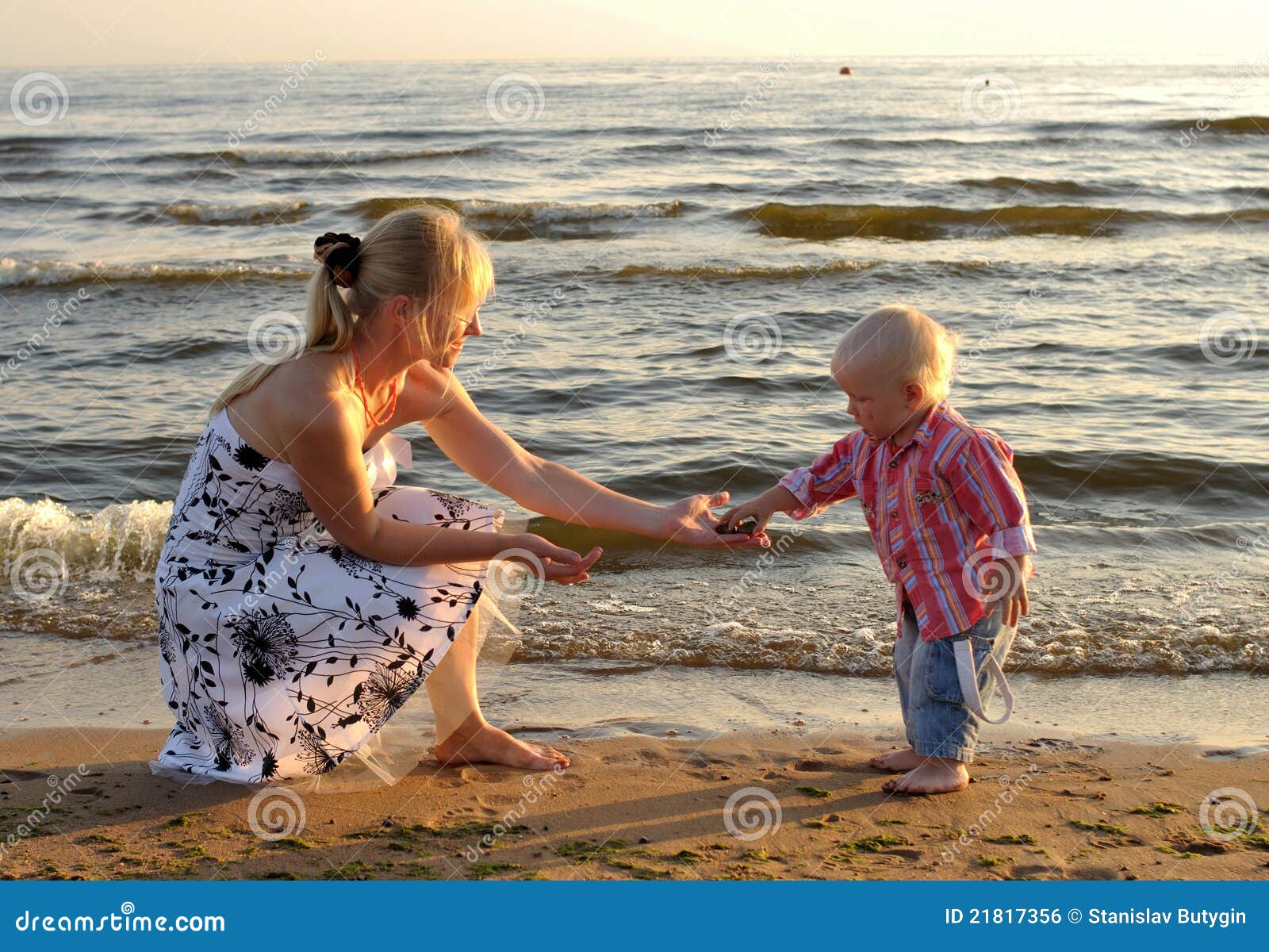 Son Passing Pebbles To His Mother Stock Photo - Image of taking, white ...