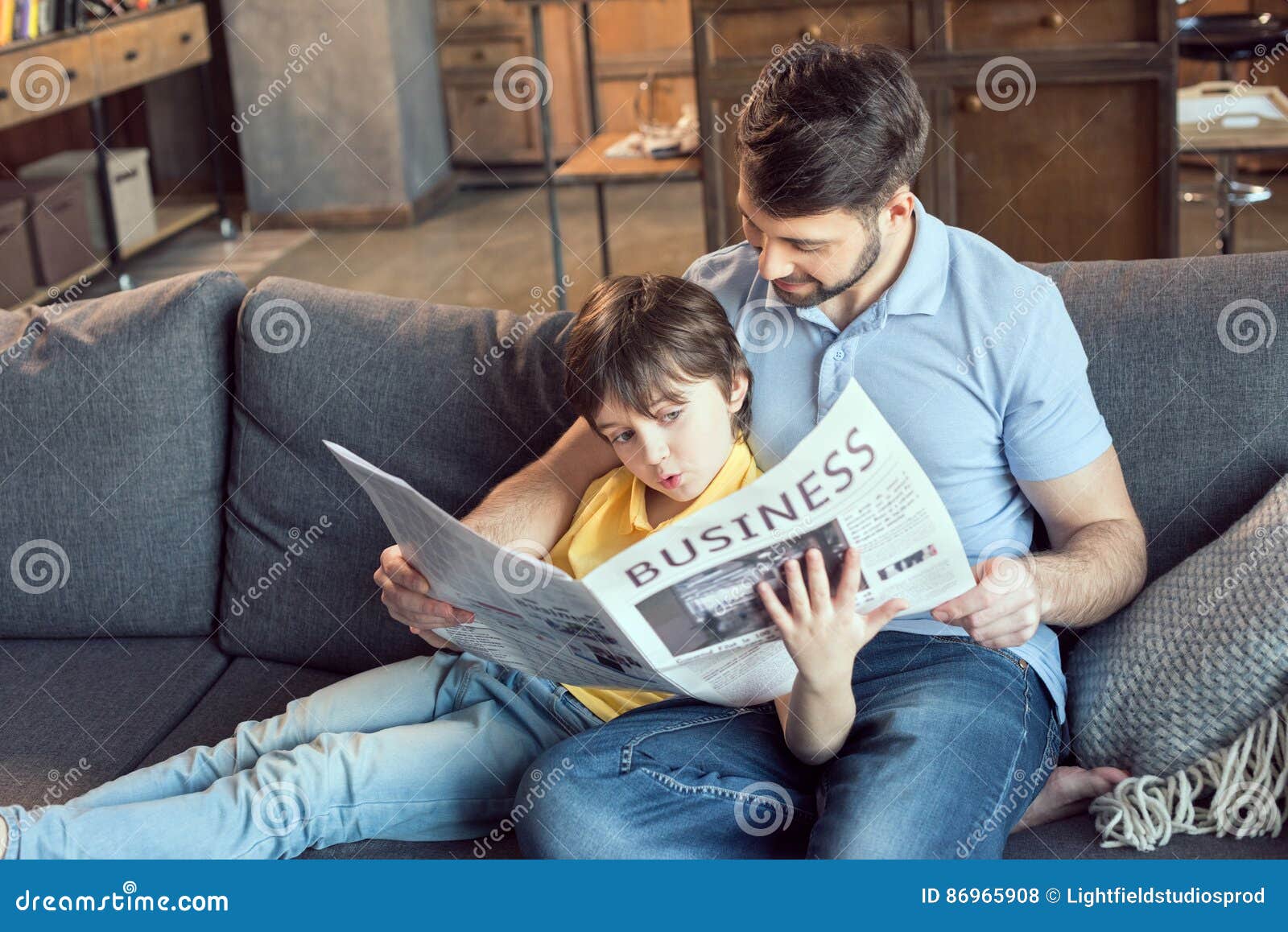 Son Reading Newspaper To Father at Home Stock Photo - Image of ...