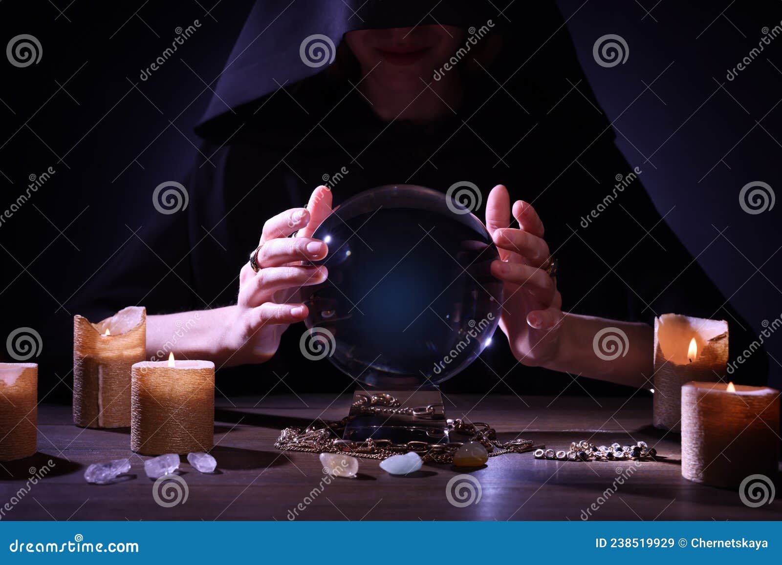 Soothsayer Using Crystal Ball To Predict Future At Table In Darkness