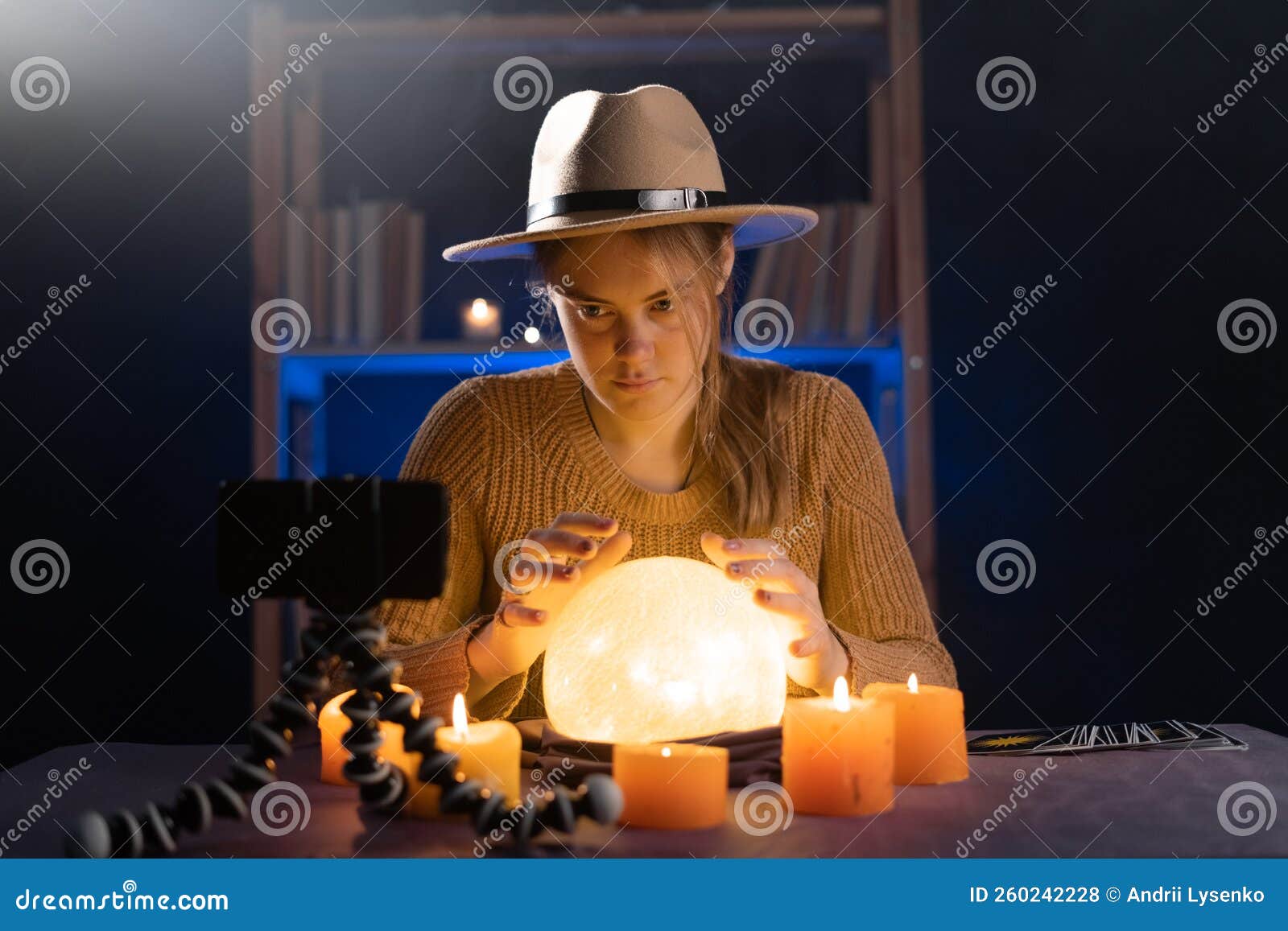 Soothsayer Using Crystal Ball To Predict Future At Table In Darkness