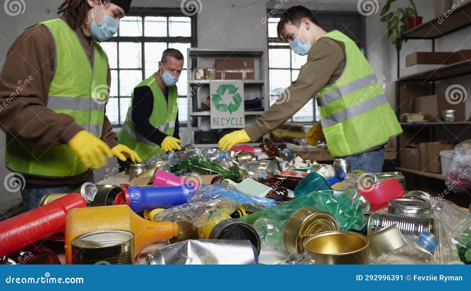 Sorting and Recycling Facility. Workers on a Conveyor Belt Manually ...