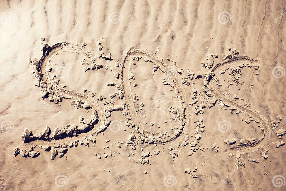 Sos sign write on sand stock photo. Image of sand, message - 112545654