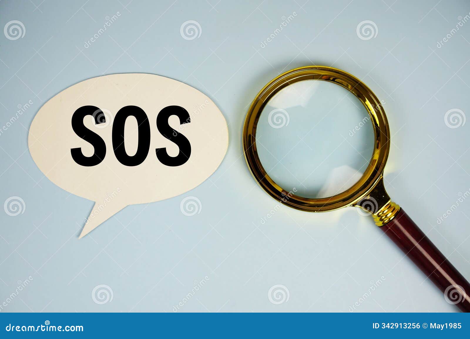 SOS Text on Speech Bubble with Magnifying Glass Top View on Blue ...